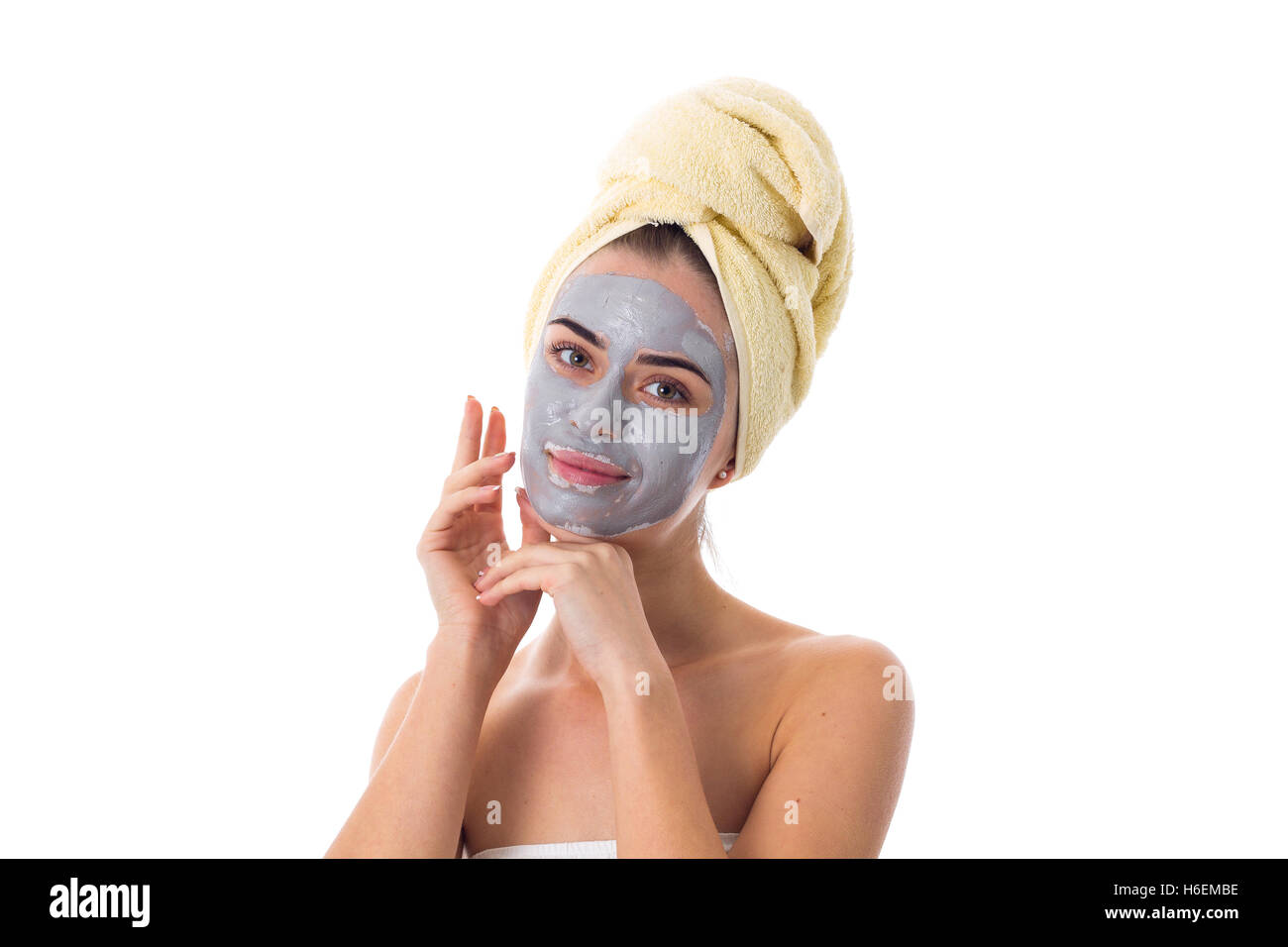 Woman with towel on her head and cosmetic mask on her face Stock Photo ...