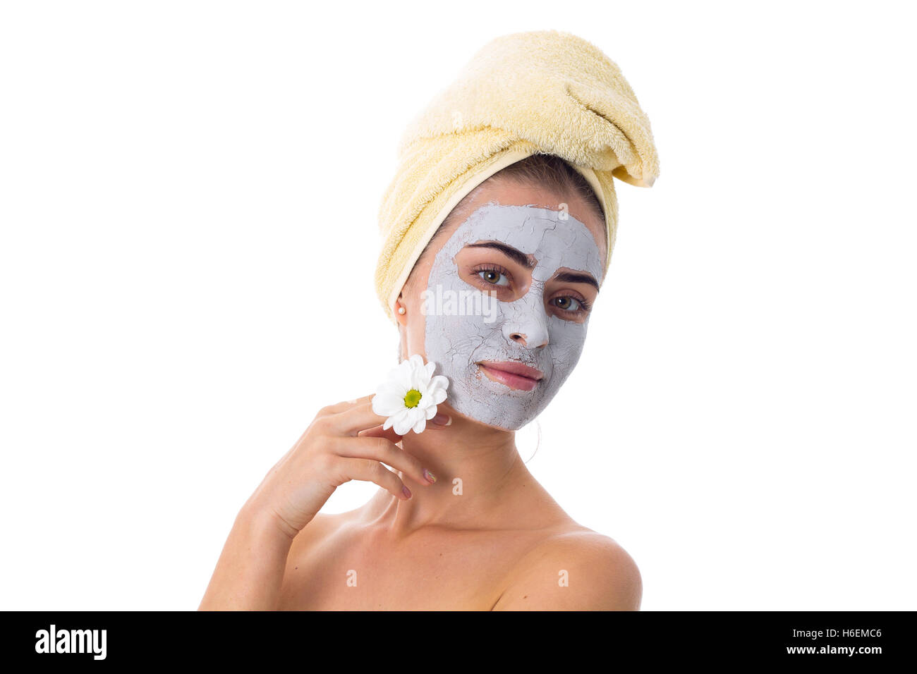 Woman with towel on her head and cosmetic mask on her face Stock Photo ...