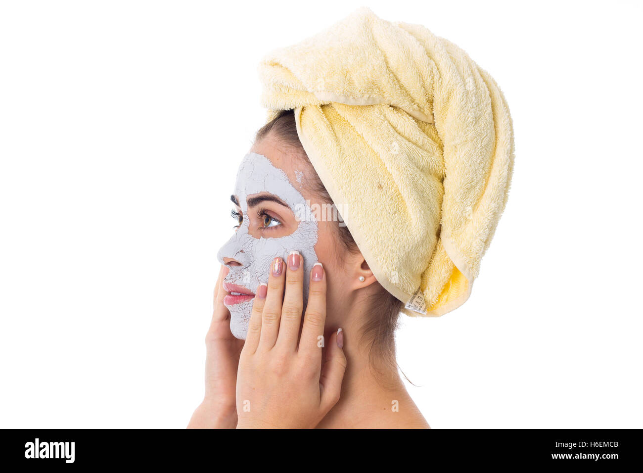 Woman with towel on her head and cosmetic mask on her face Stock Photo ...