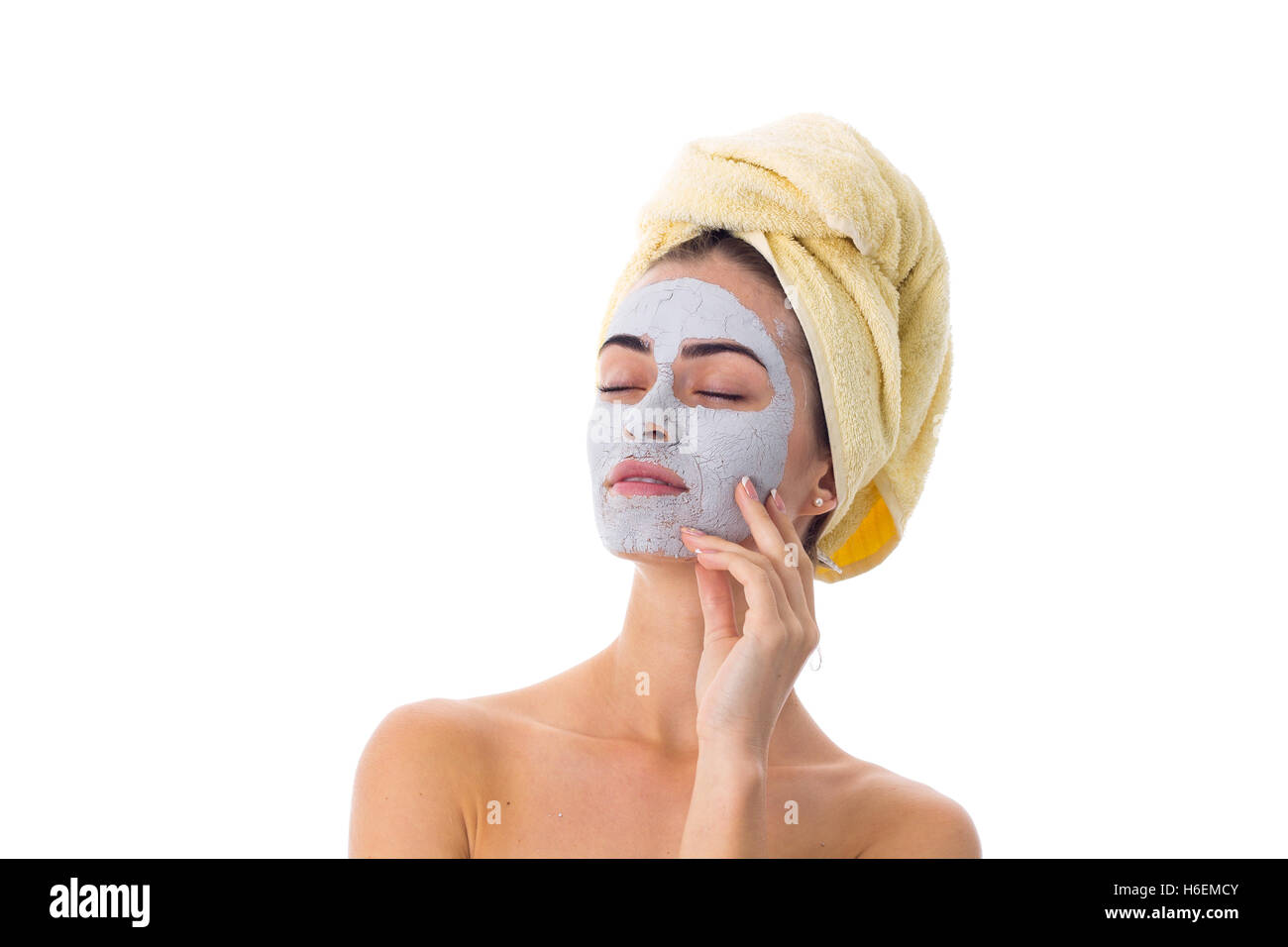 Woman with towel on her head and cosmetic mask on her face Stock Photo ...