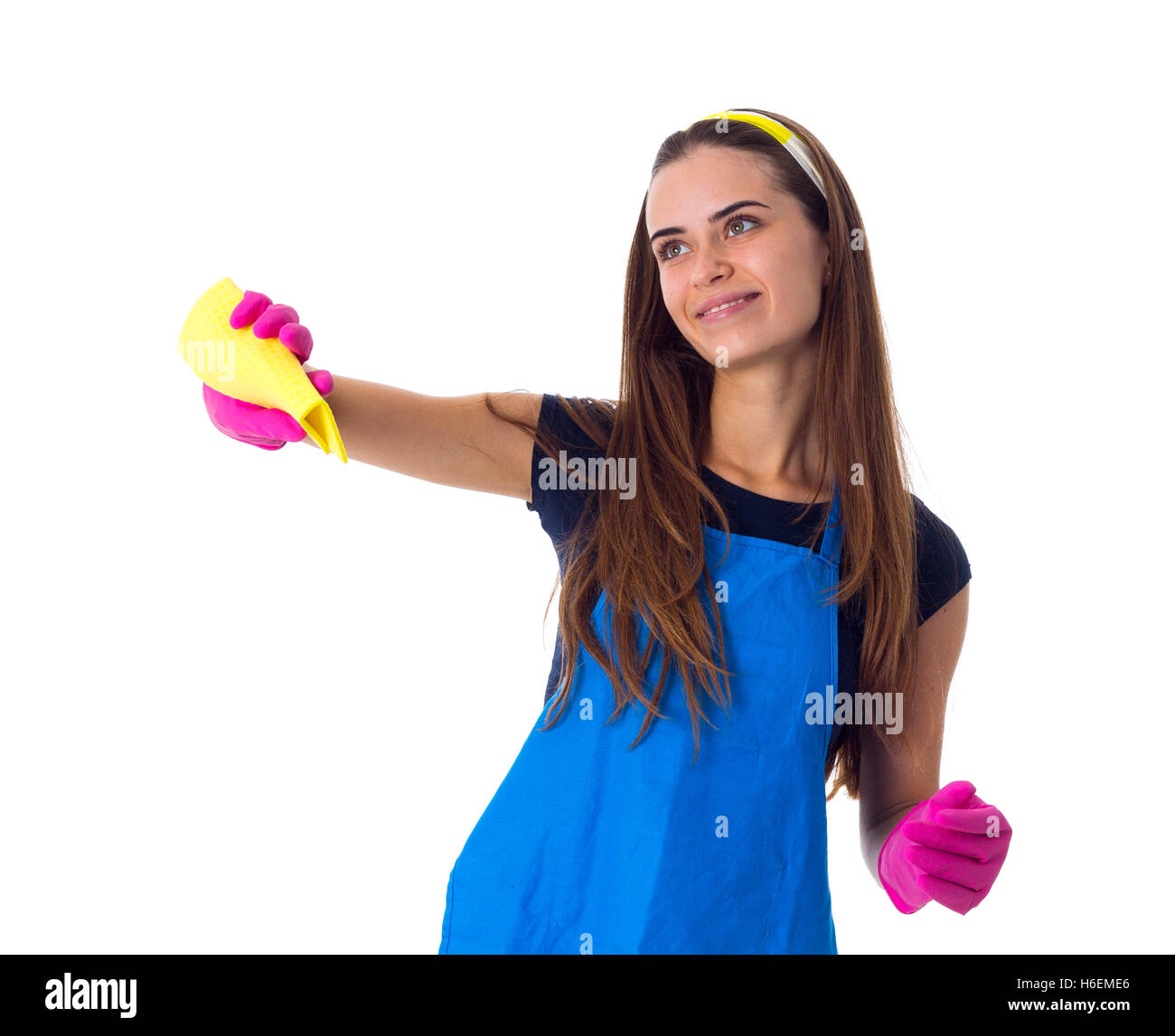 Woman in apron using a duster Stock Photo - Alamy