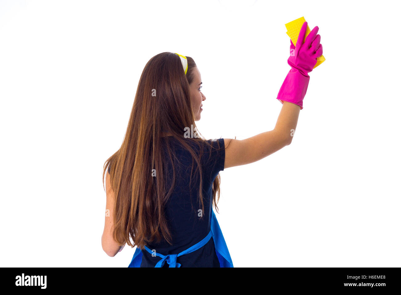 Woman in apron using a duster Stock Photo - Alamy