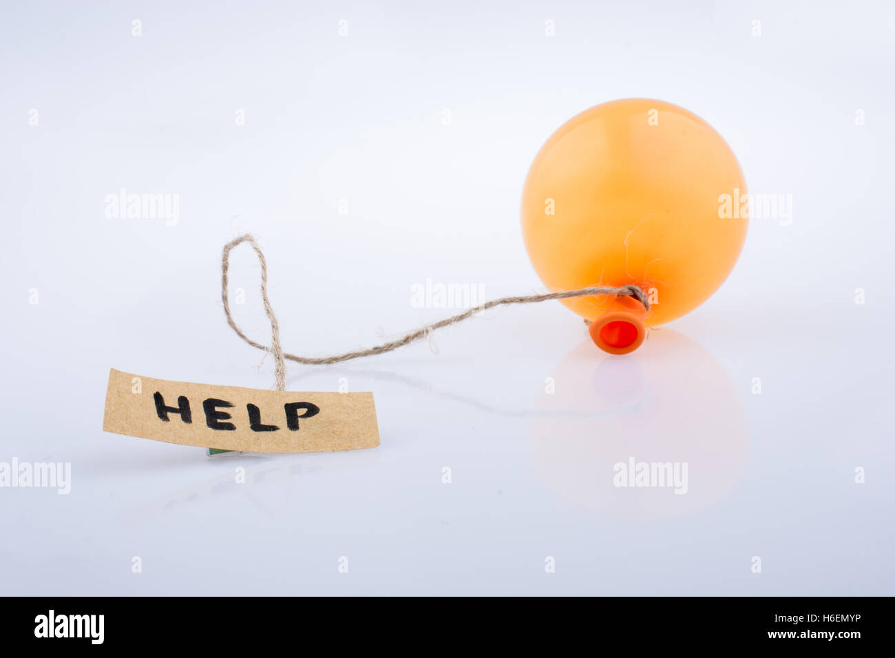Help word written paper attached to a balloon with a string Stock Photo ...