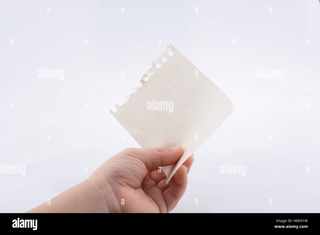 Hand holding a note paper on a white background Stock Photo - Alamy