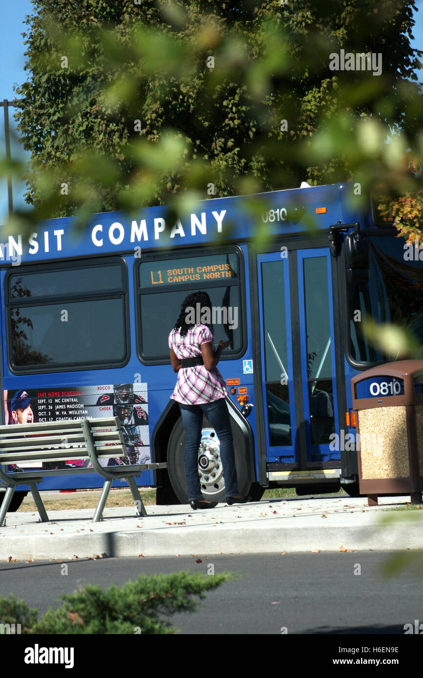 Young girl ready to step up in a city transit bus Stock Photo - Alamy