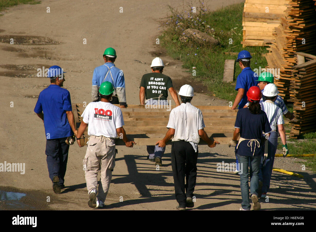 Group of people working together on construction site Stock Photo - Alamy