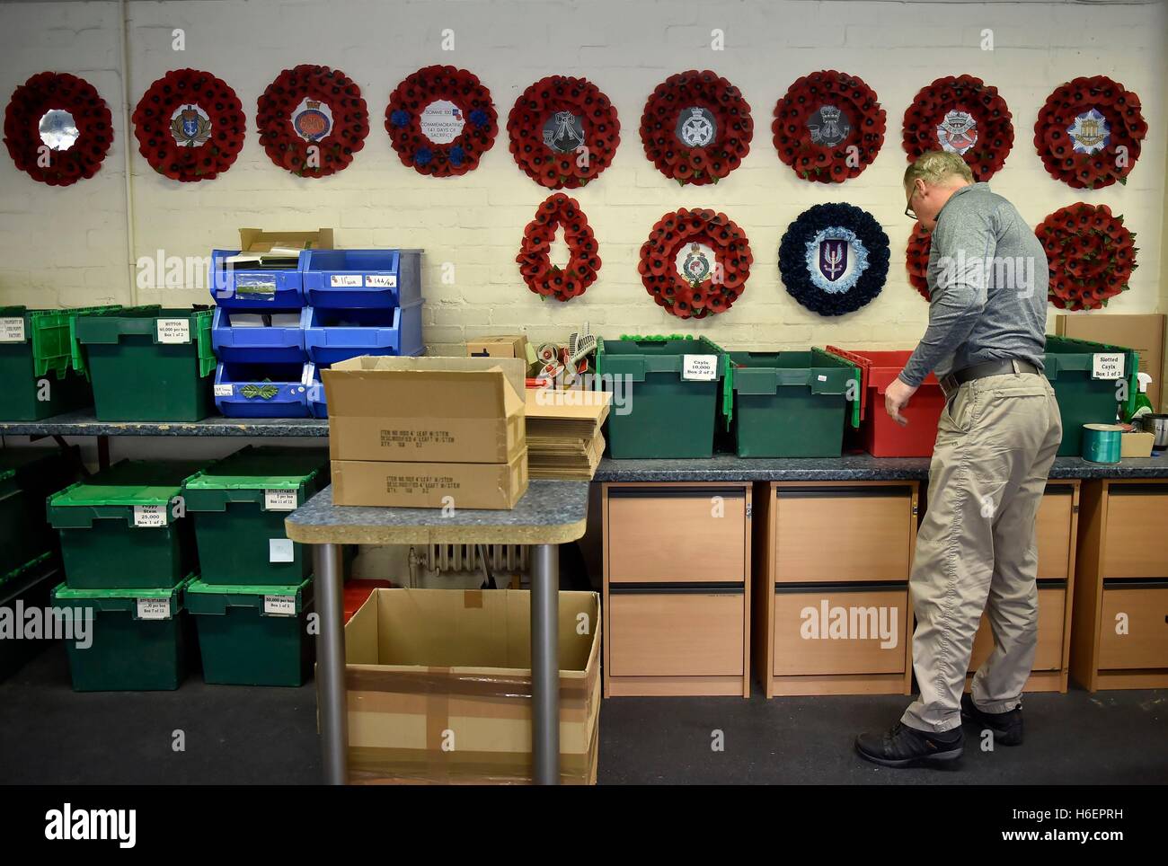 A worker collects the components of a standard poppy out of boxes at a ...