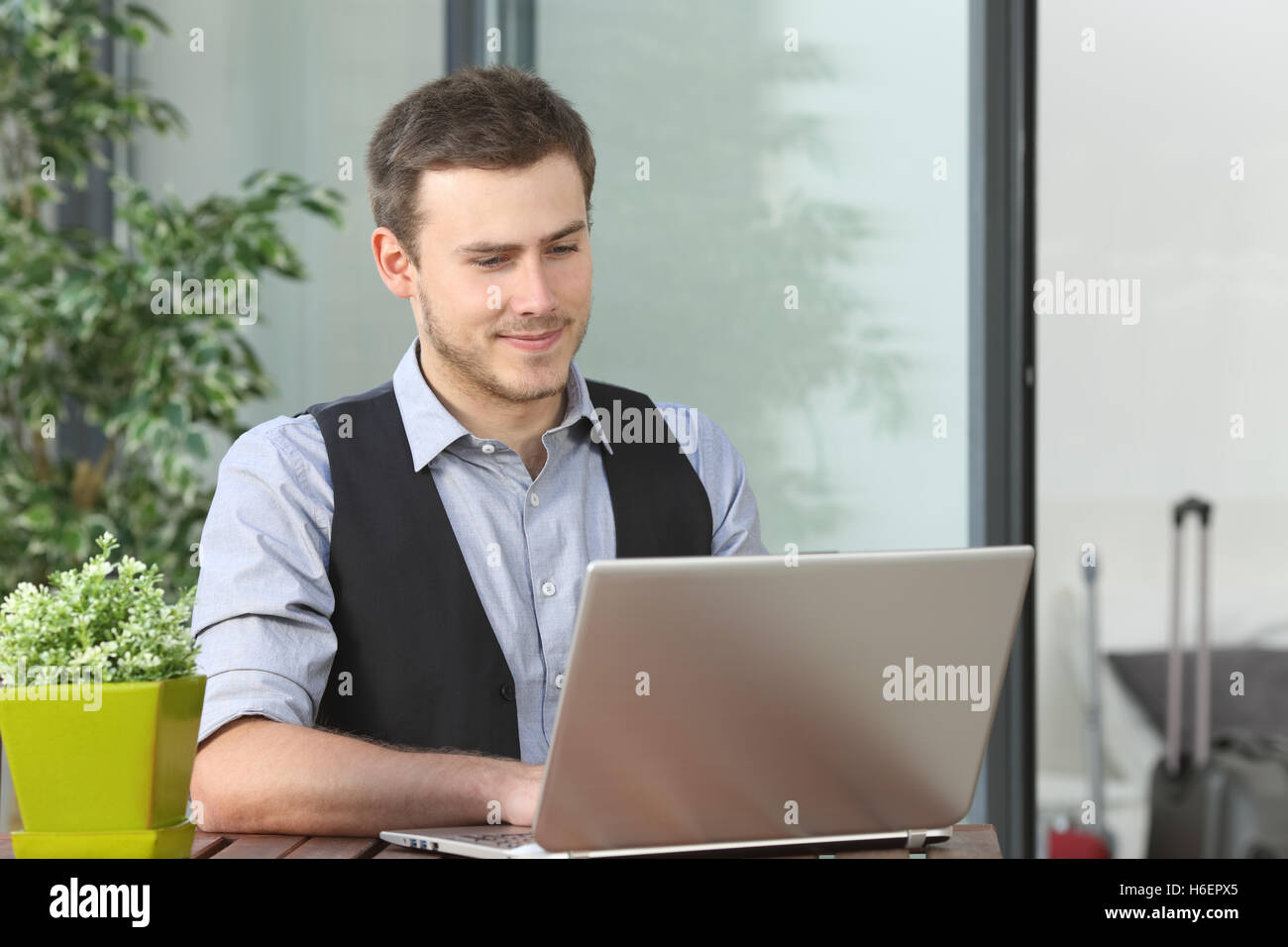 Executive working in an hotel outdoor in the balcony during a business ...