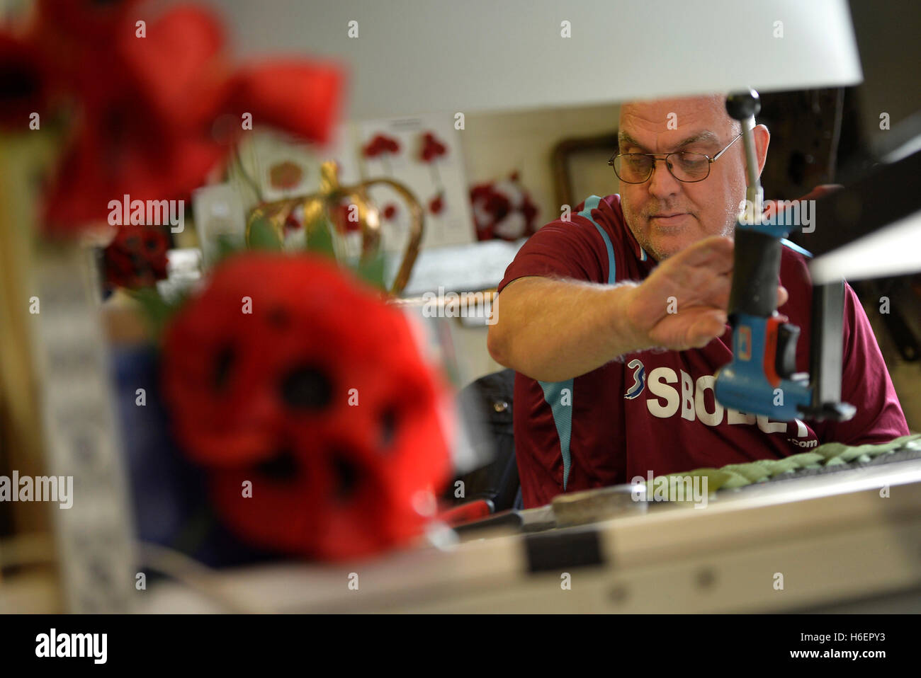 A worker puts together the components of RAF poppy display at a Poppy ...