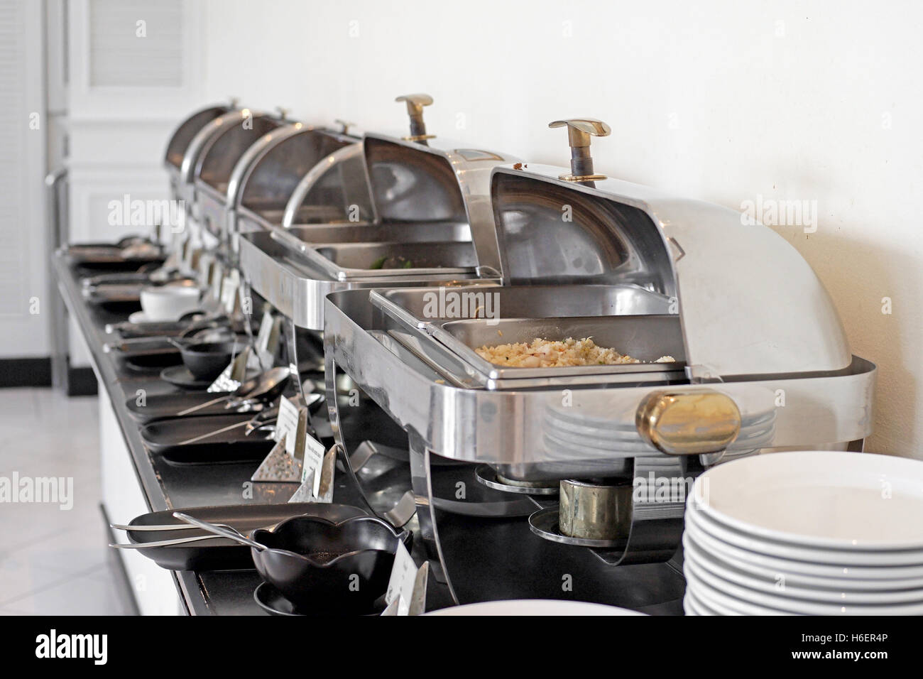 row of food service steam pans on buffet table Stock Photo - Alamy