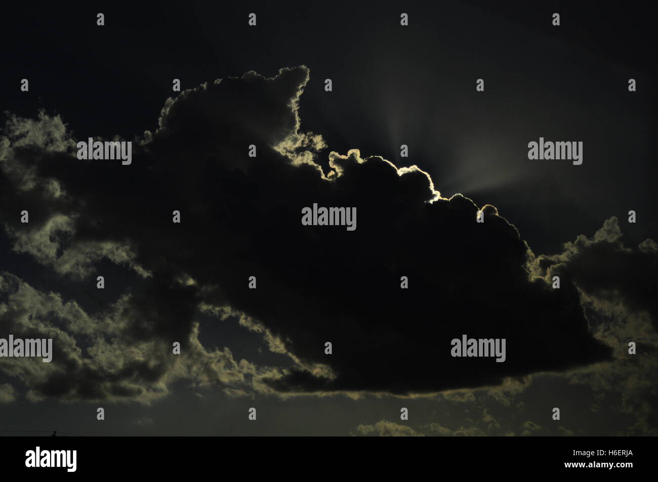 Sun hidden behind clouds Stock Photo - Alamy