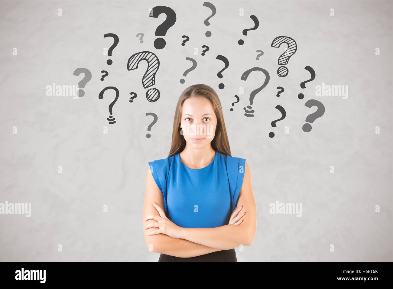 Bored and sad woman with lots of doubts and question marks around her ...