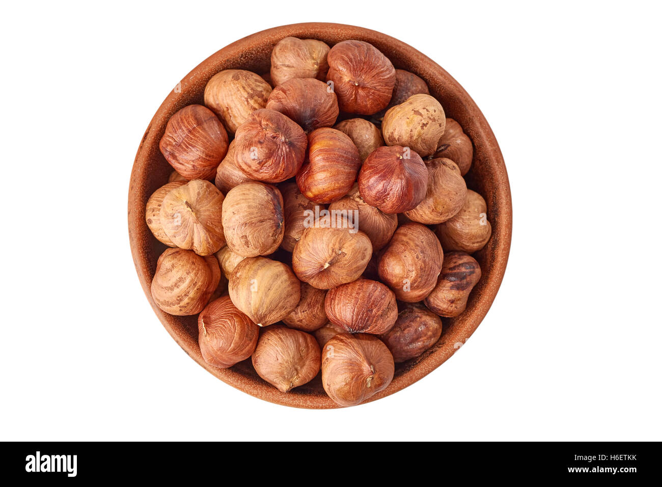 Ceramic bowl of hazelnuts on white Stock Photo - Alamy