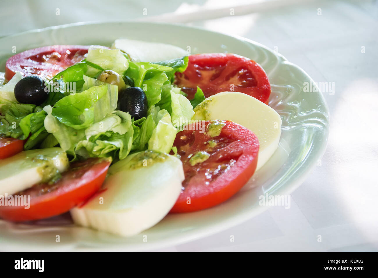 Caprese salad with tomatoes, mozzarella cheese, salad and olive ...