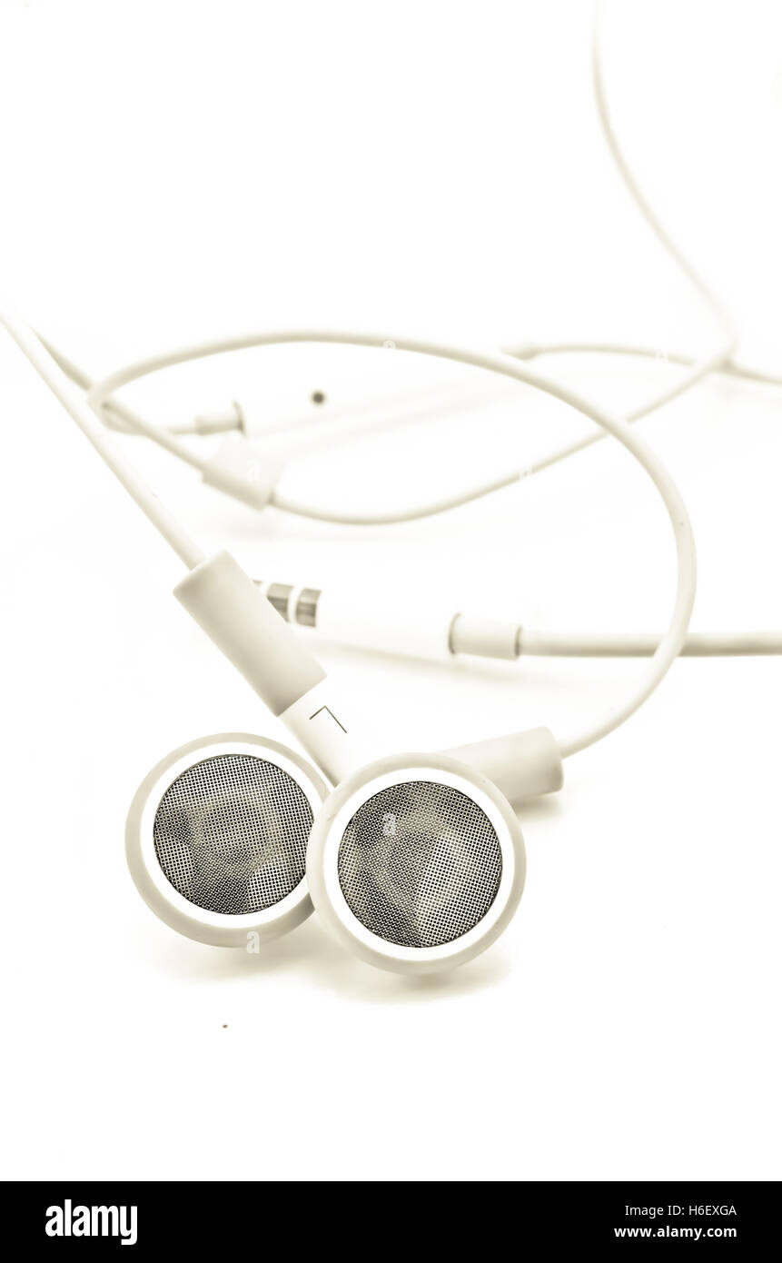White earphones on white background Stock Photo - Alamy