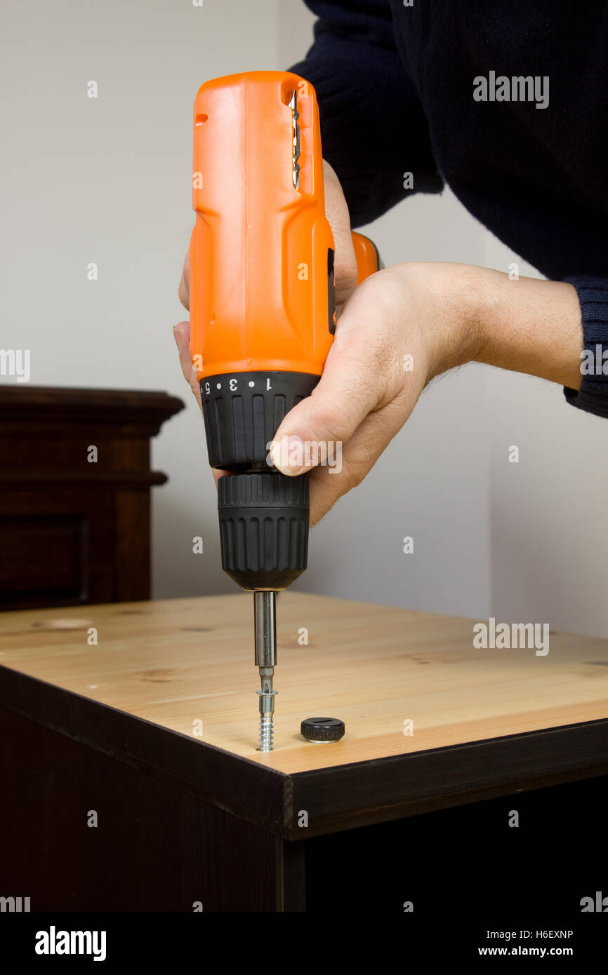 carpenter fitting a piece of furniture in a house Stock Photo - Alamy