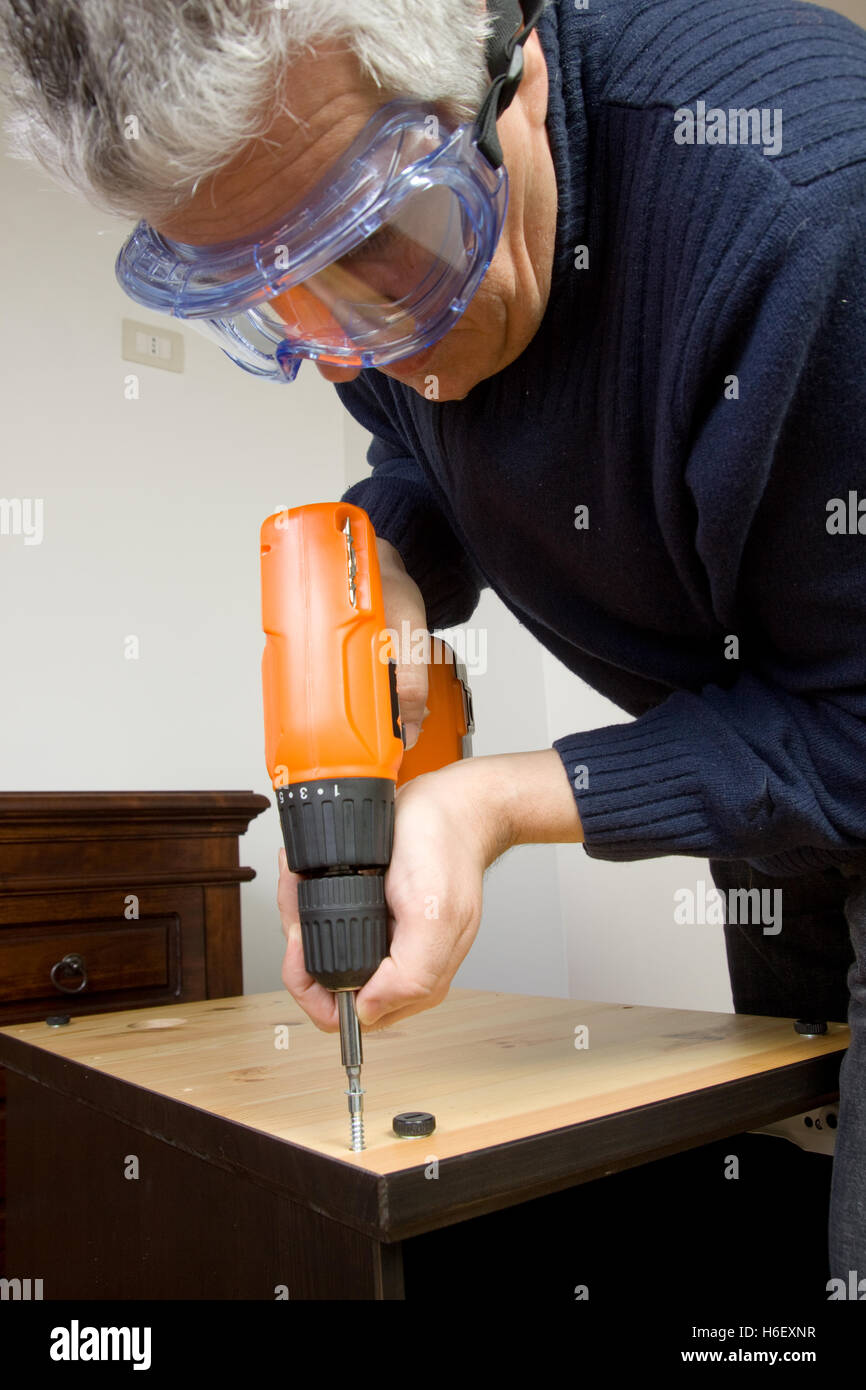 carpenter fitting a piece of furniture in a house Stock Photo - Alamy