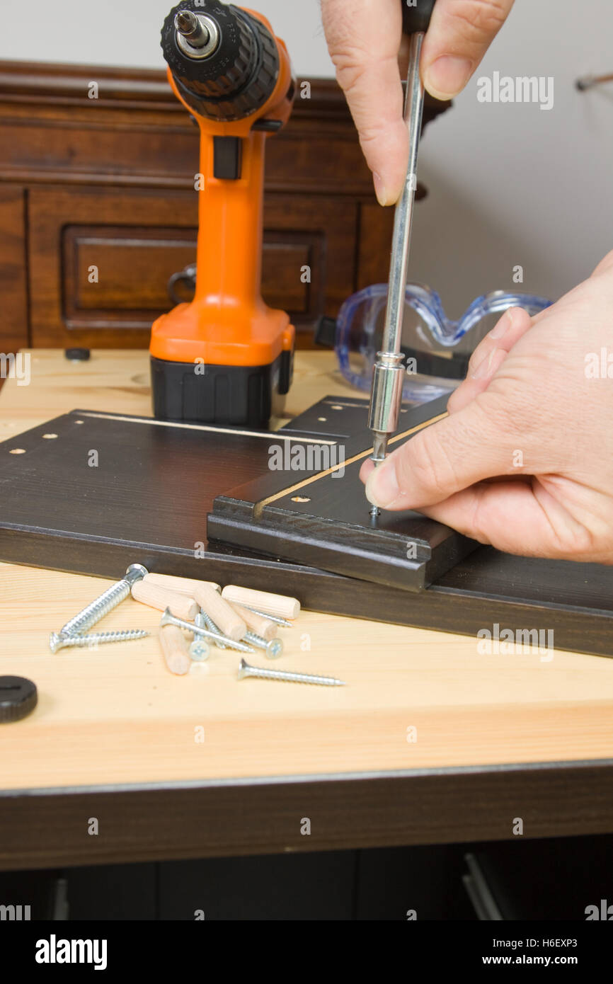 carpenter fitting a piece of furniture in a house Stock Photo - Alamy