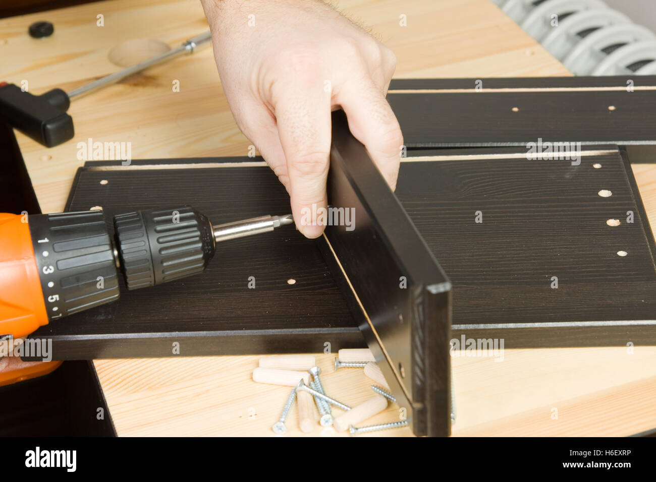 carpenter fitting a piece of furniture in a house Stock Photo - Alamy