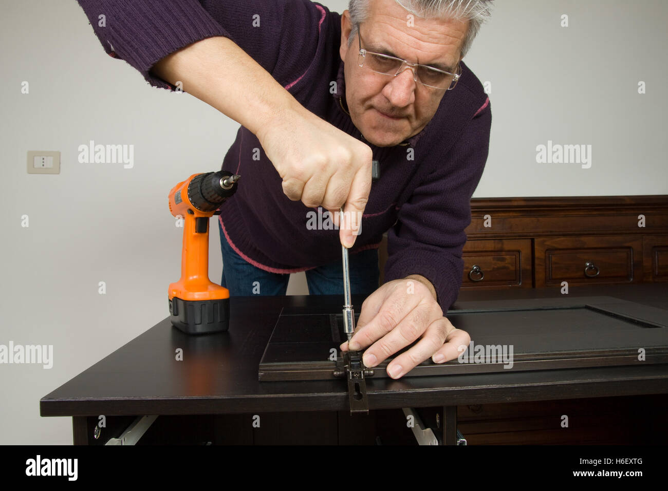 carpenter fitting a piece of furniture in a house Stock Photo - Alamy