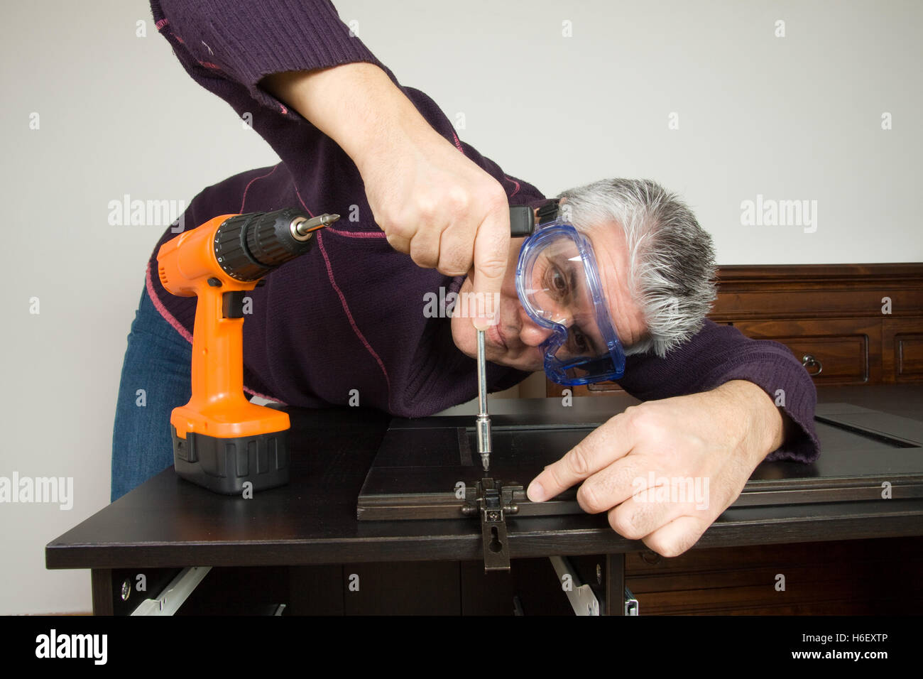 carpenter fitting a piece of furniture in a house Stock Photo - Alamy