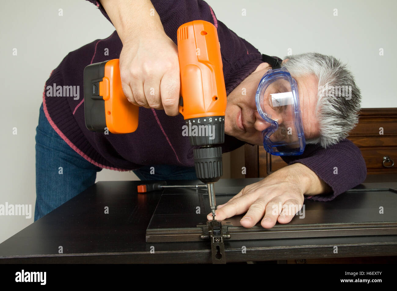 carpenter fitting a piece of furniture in a house Stock Photo - Alamy