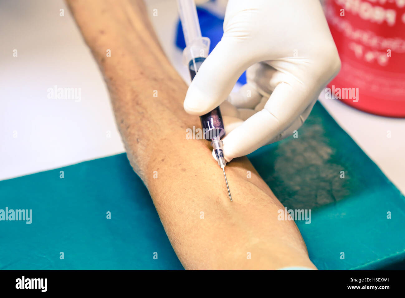Shot of human hands making an injection with a syringe Stock Photo - Alamy
