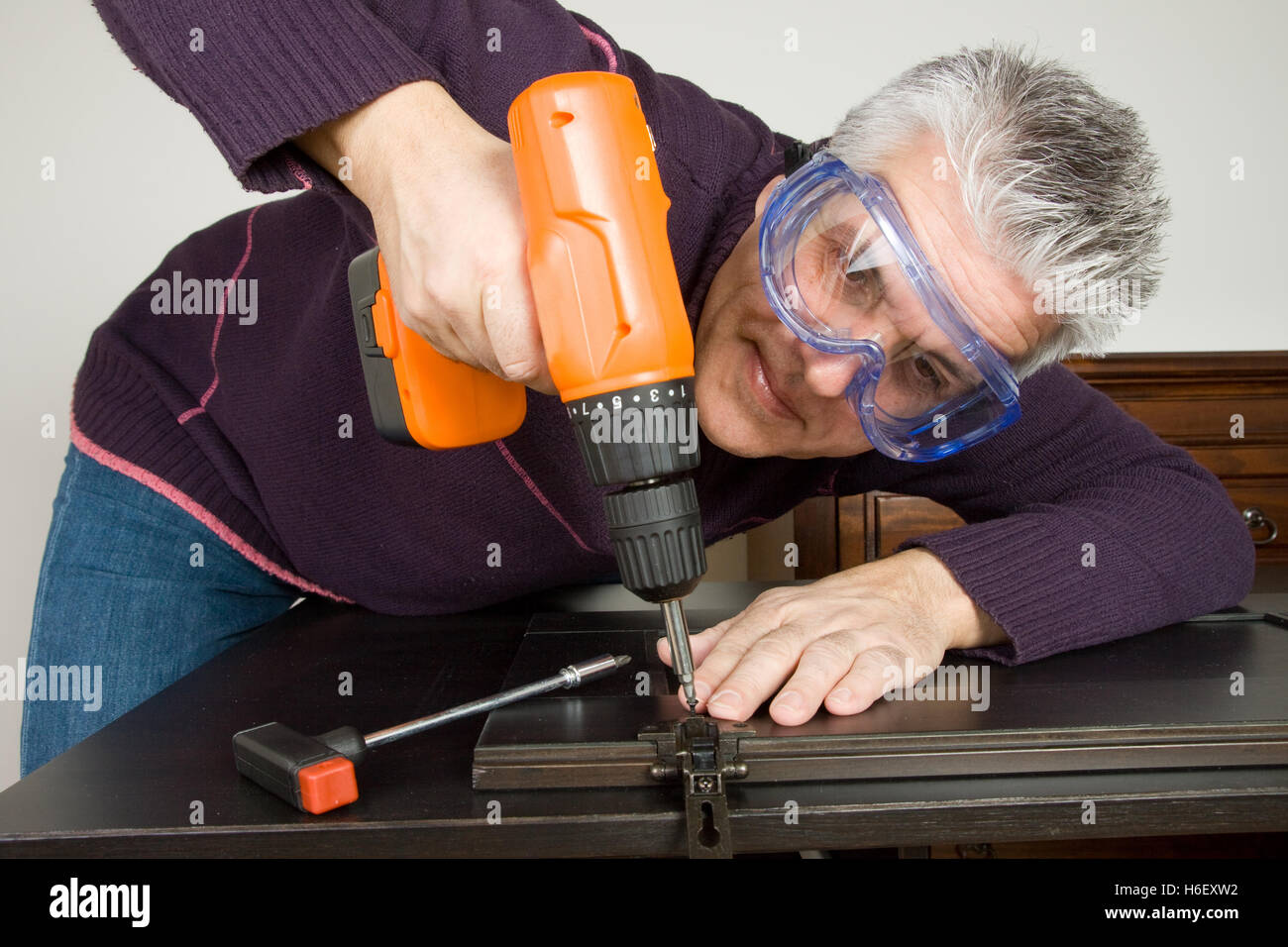 carpenter fitting a piece of furniture in a house Stock Photo - Alamy