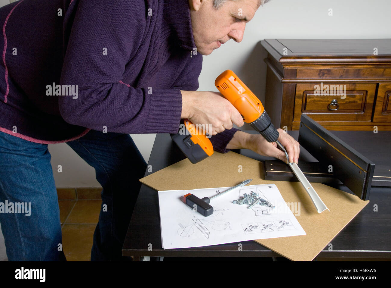 carpenter fitting a piece of furniture in a house Stock Photo - Alamy