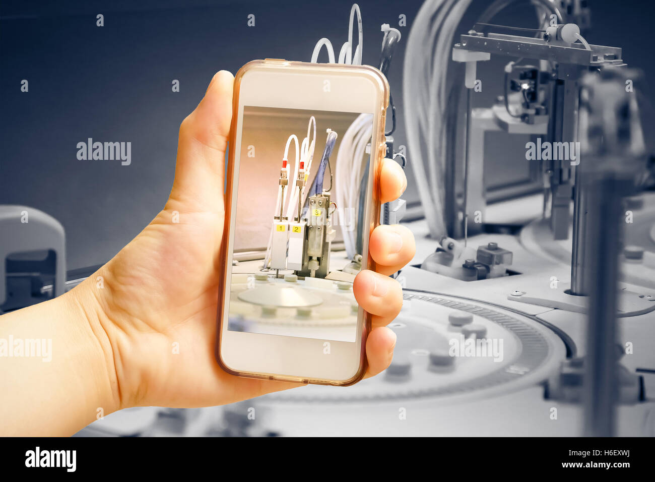 Hand holding smart phone (Mobile Phone) with centrifuge. advanced ...