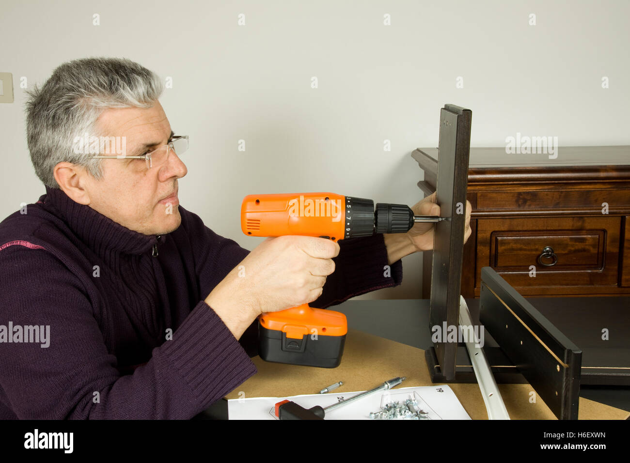 carpenter fitting a piece of furniture in a house Stock Photo - Alamy