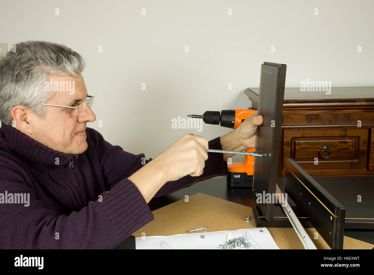 carpenter fitting a piece of furniture in a house Stock Photo - Alamy