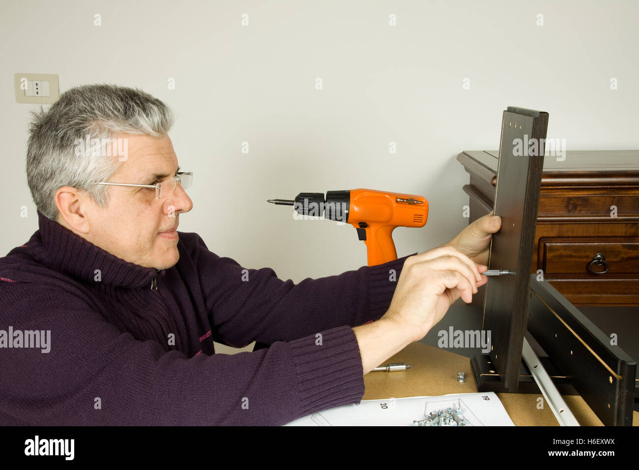 carpenter fitting a piece of furniture in a house Stock Photo - Alamy