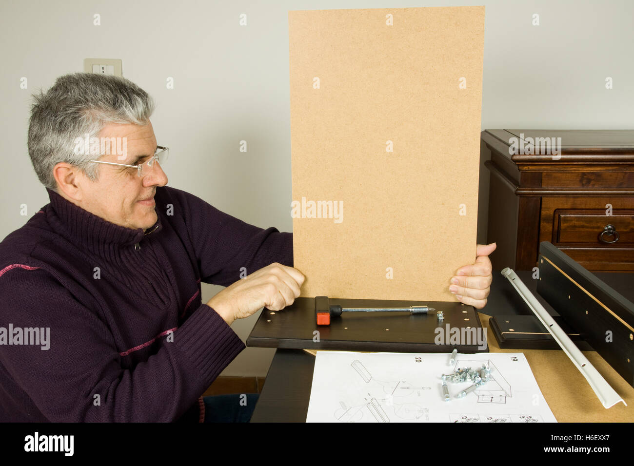 carpenter fitting a piece of furniture in a house Stock Photo - Alamy