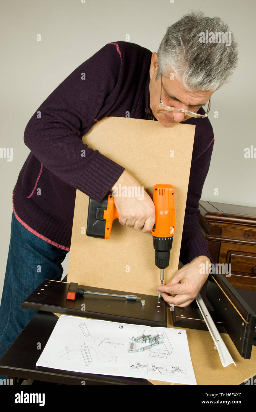 carpenter fitting a piece of furniture in a house Stock Photo - Alamy