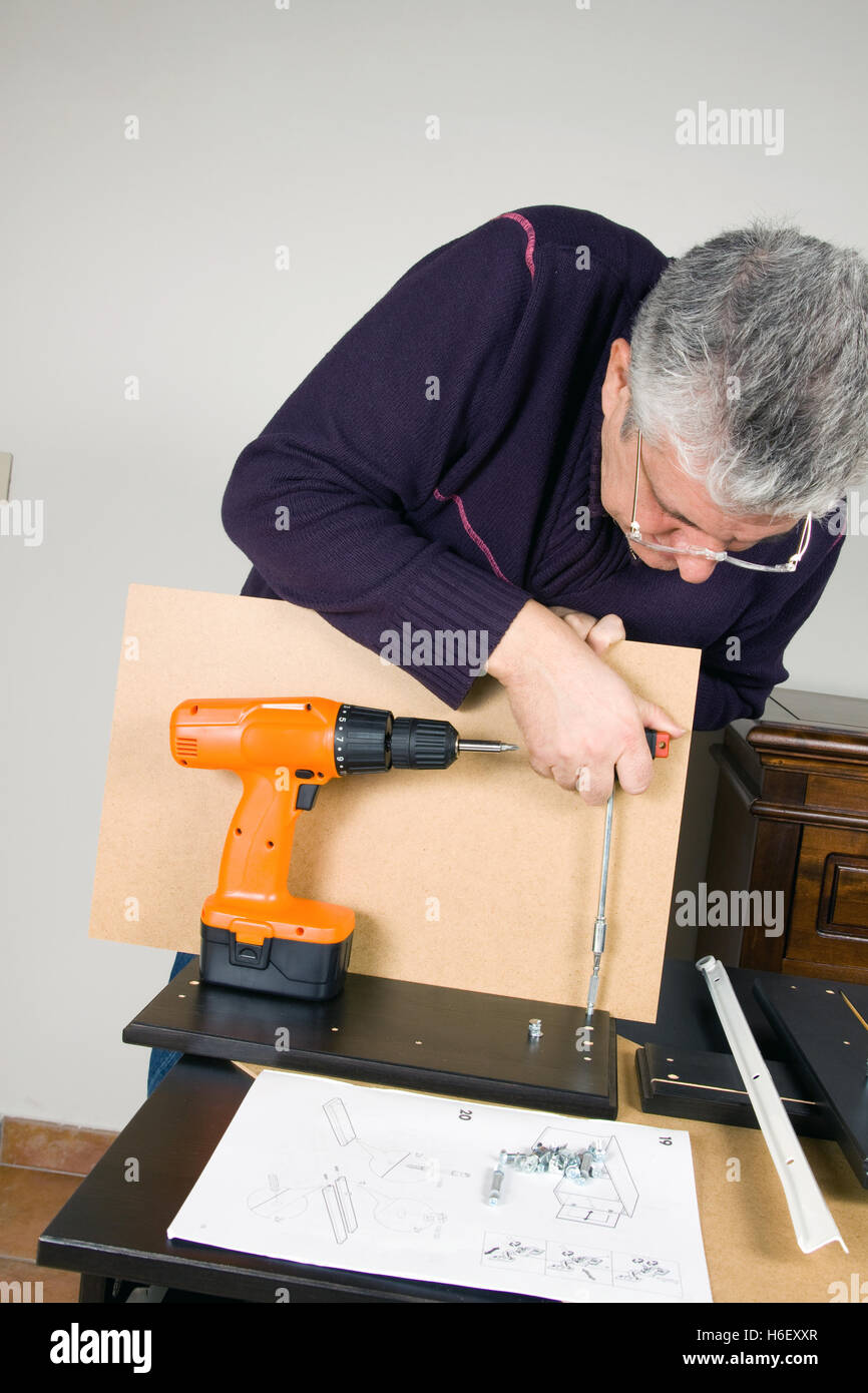 carpenter fitting a piece of furniture in a house Stock Photo - Alamy