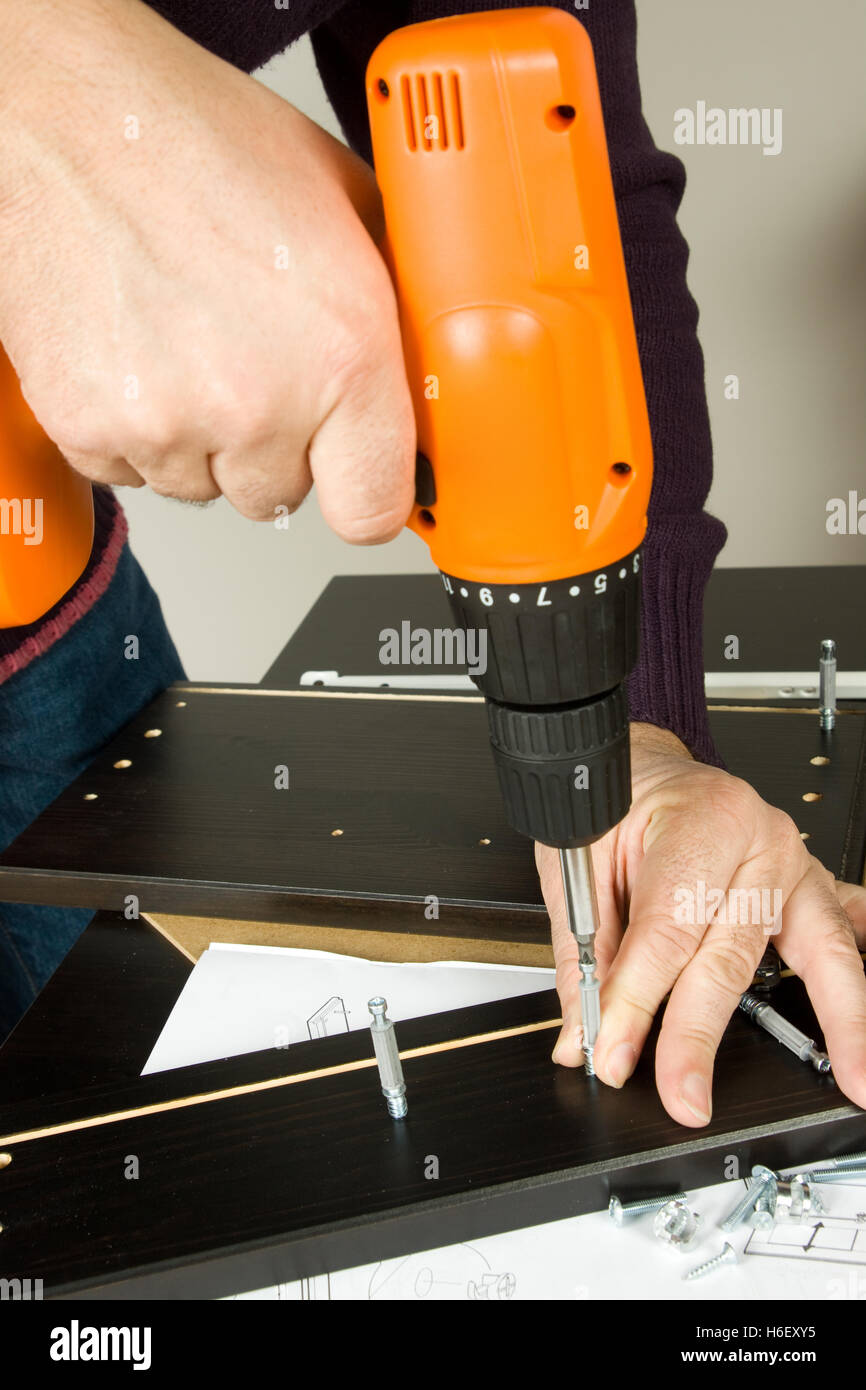 carpenter fitting a piece of furniture in a house Stock Photo - Alamy