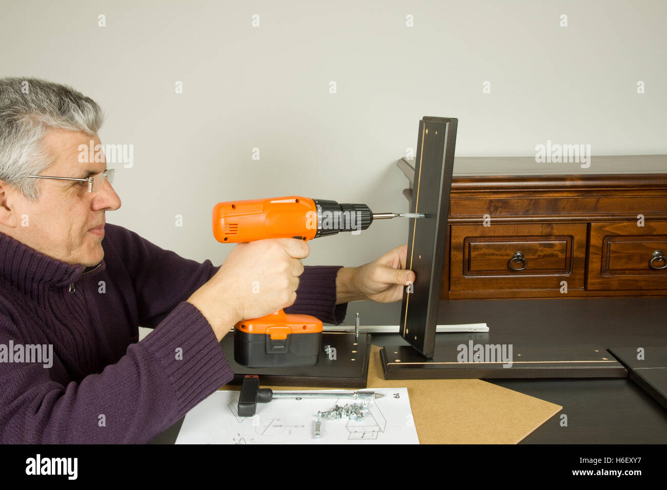 carpenter fitting a piece of furniture in a house Stock Photo - Alamy