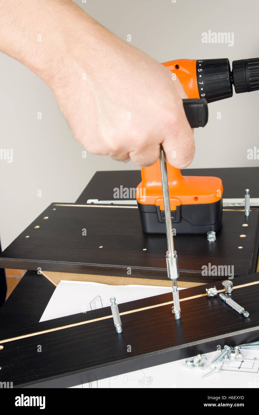 carpenter fitting a piece of furniture in a house Stock Photo - Alamy