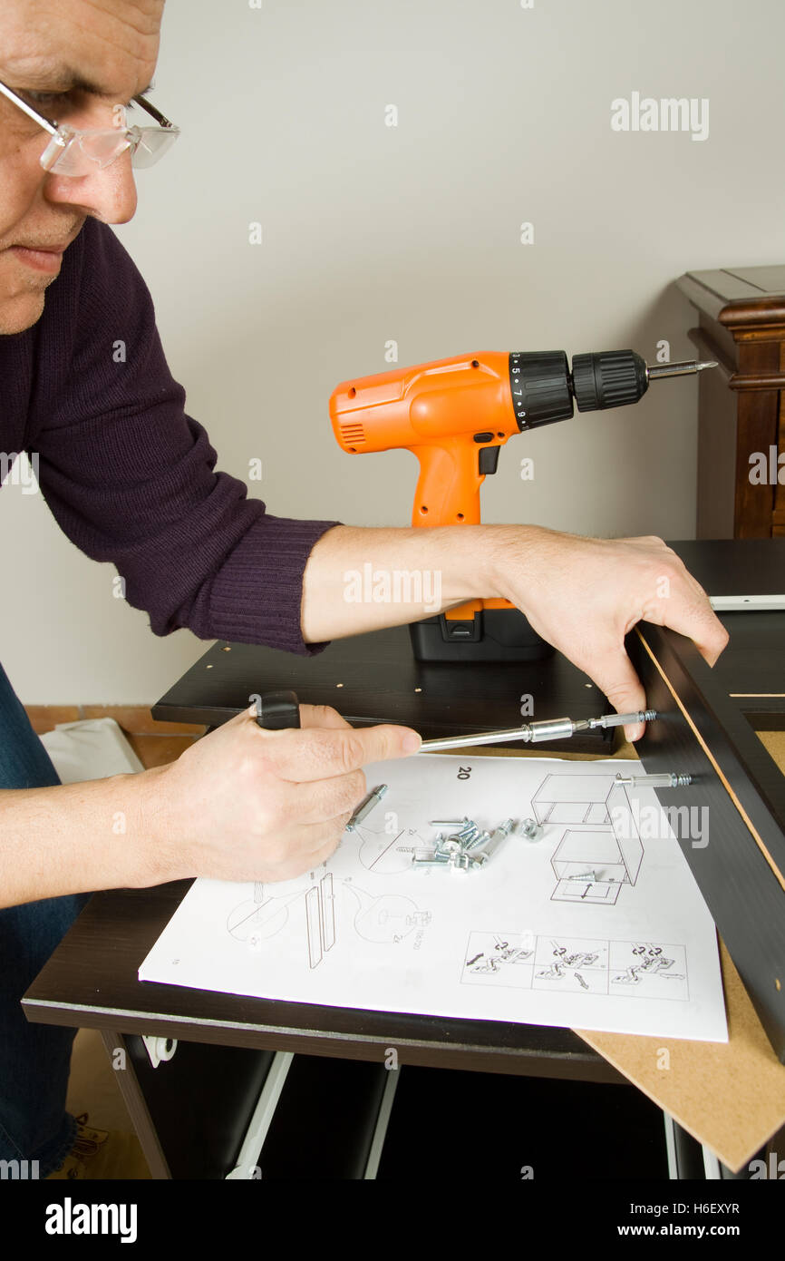 carpenter fitting a piece of furniture in a house Stock Photo - Alamy