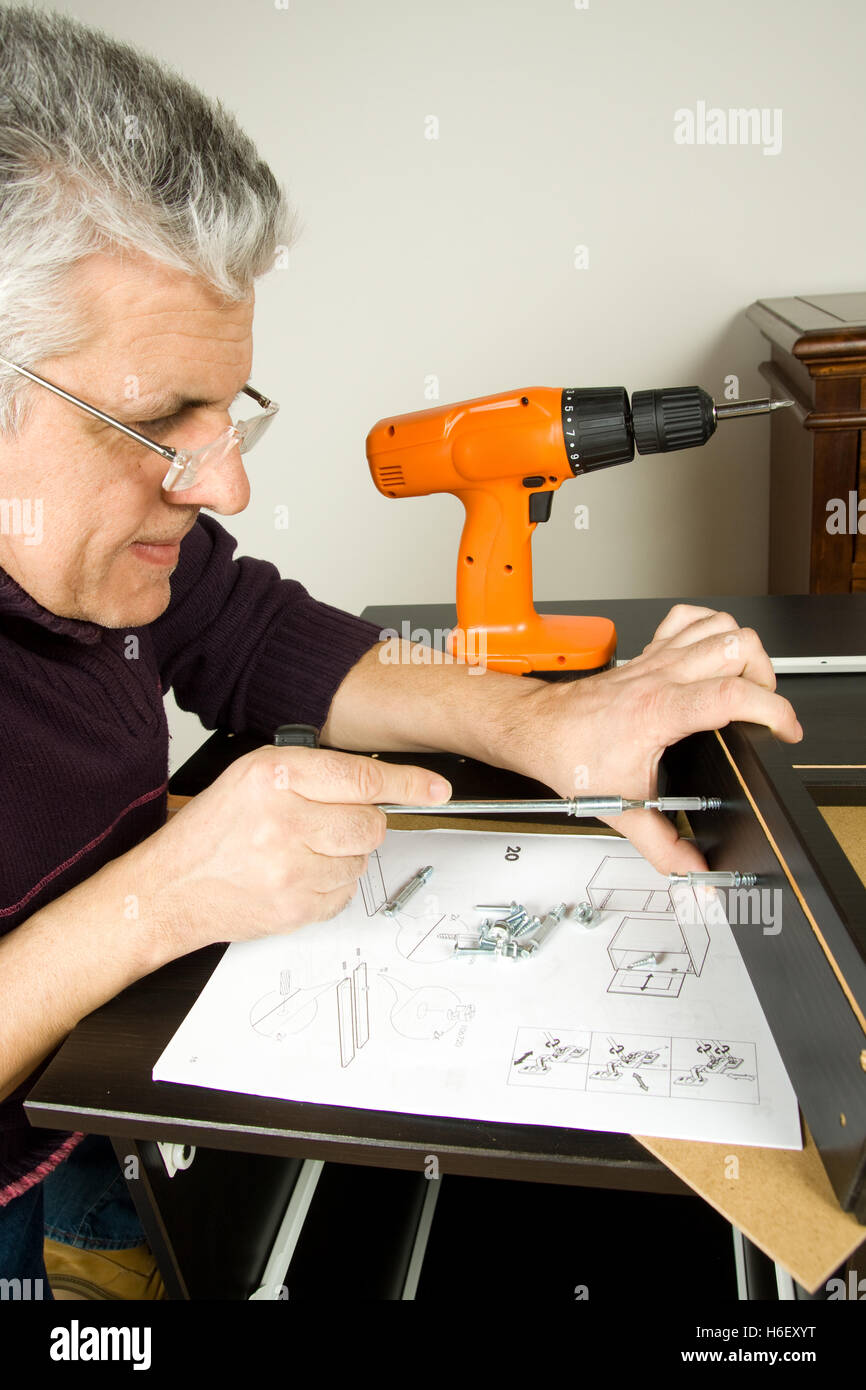 carpenter fitting a piece of furniture in a house Stock Photo - Alamy