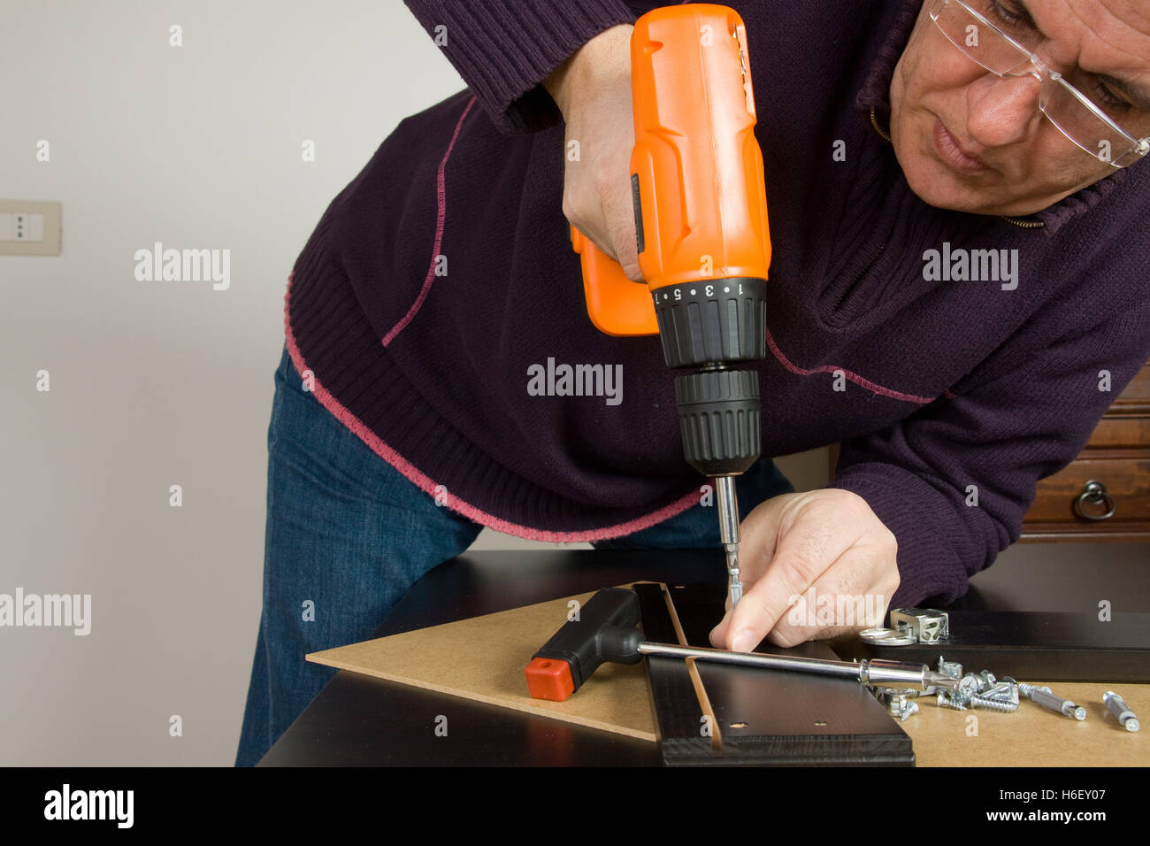 carpenter fitting a piece of furniture in a house Stock Photo - Alamy