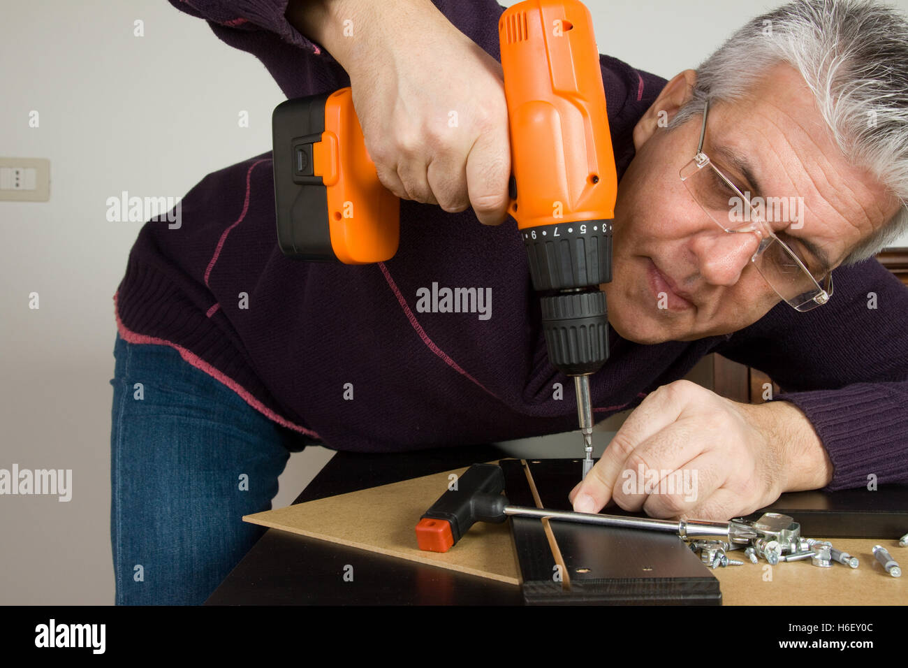 carpenter fitting a piece of furniture in a house Stock Photo - Alamy