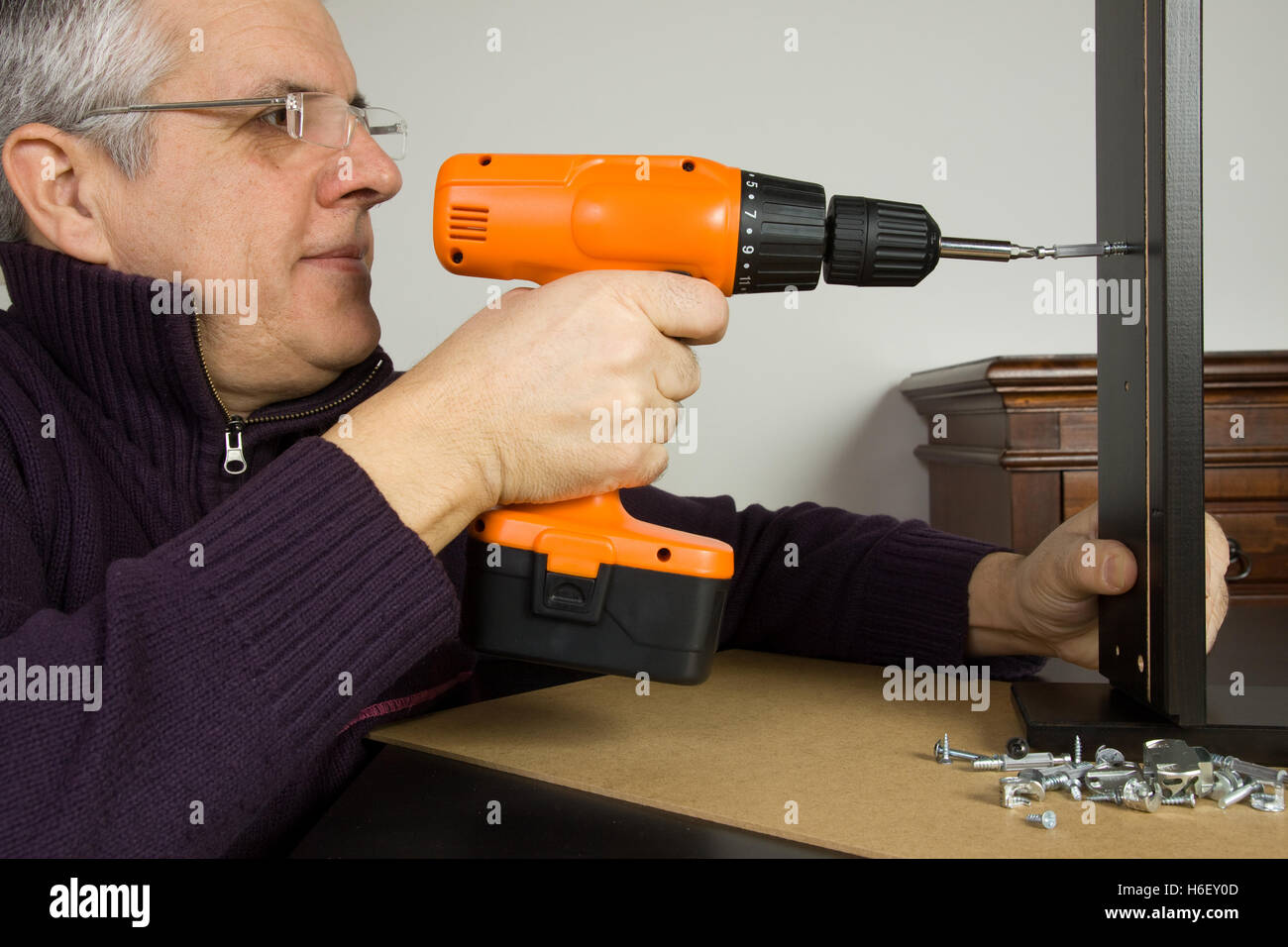 carpenter fitting a piece of furniture in a house Stock Photo - Alamy
