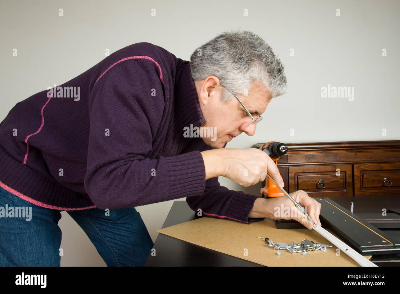carpenter fitting a piece of furniture in a house Stock Photo - Alamy