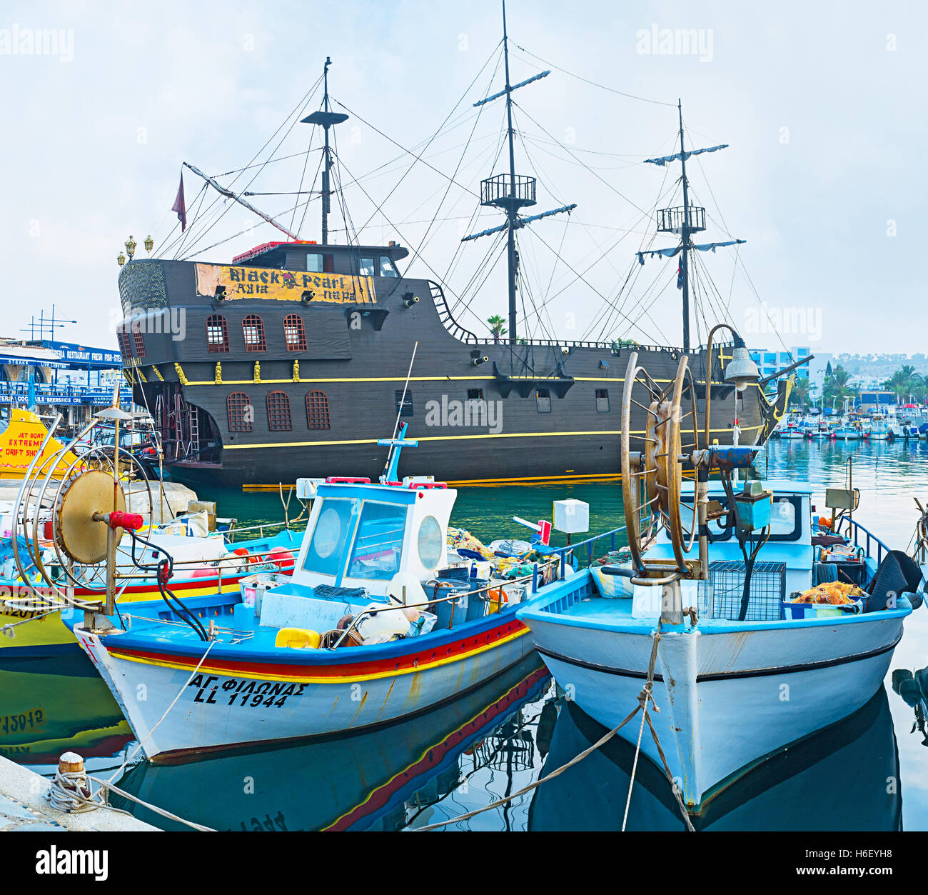 The small fishing boats with the replica of the medieval galleon on the ...