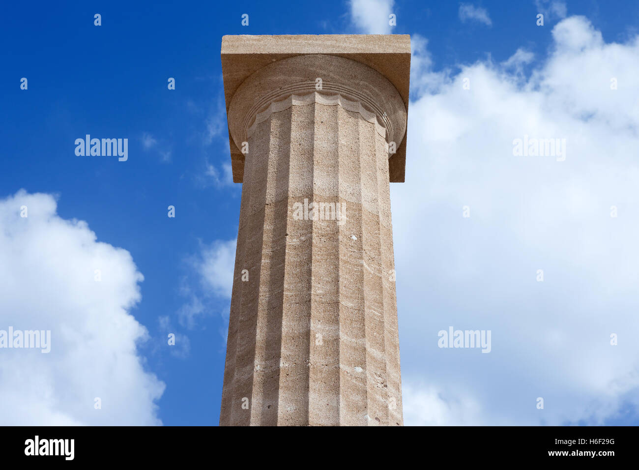 Ancient Greek pillars at the Athens acropolis with blue cloudy sky in the background Stock Photo ...