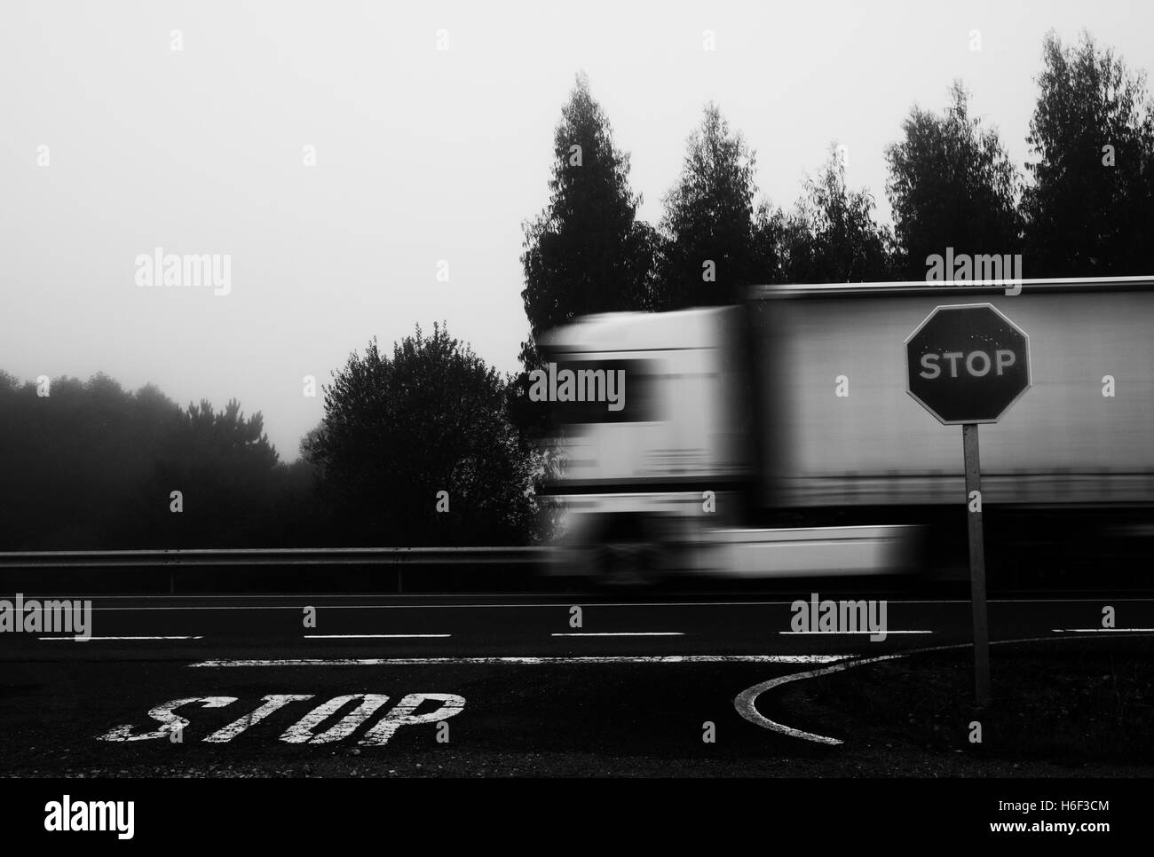 photo of truck speeding on road passing stop sign and stop letters ...