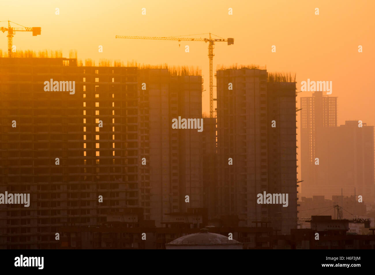 Buildings under construction at dusk Stock Photo - Alamy