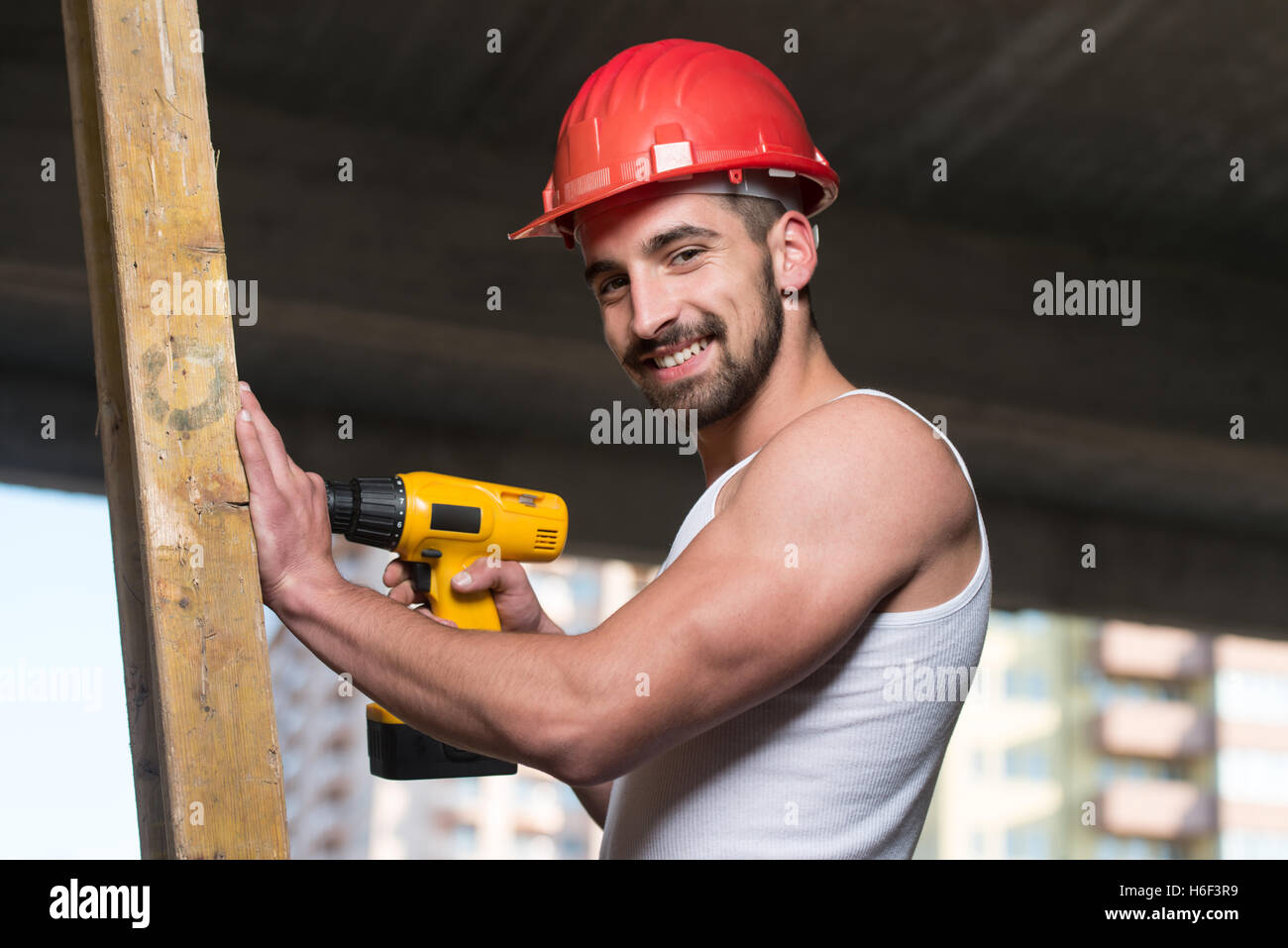Successful Male Architect At A Building Site Trying To Drill A Large ...